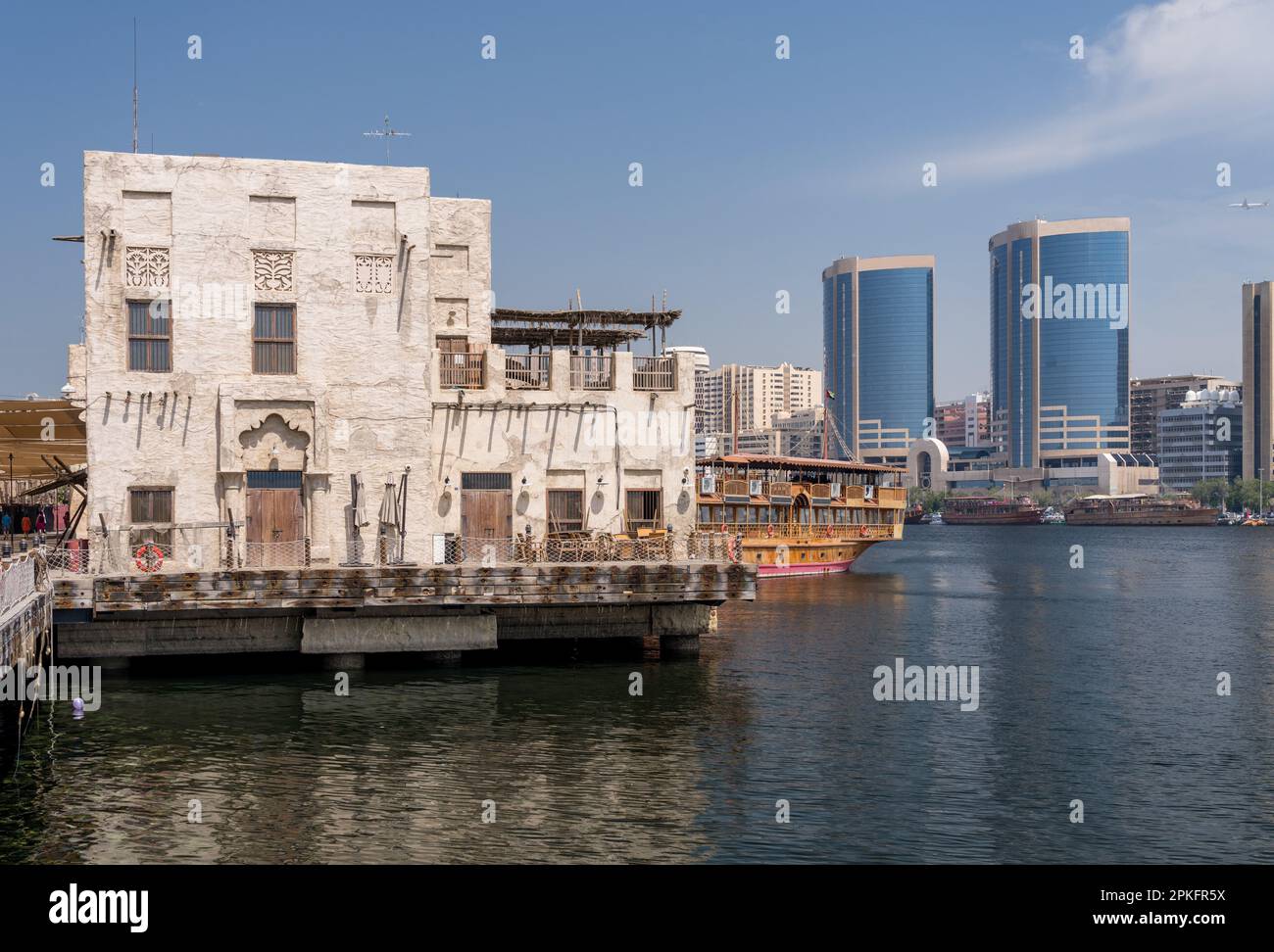 View along the Creek towards Deira with large dhow tour boats docked by ...