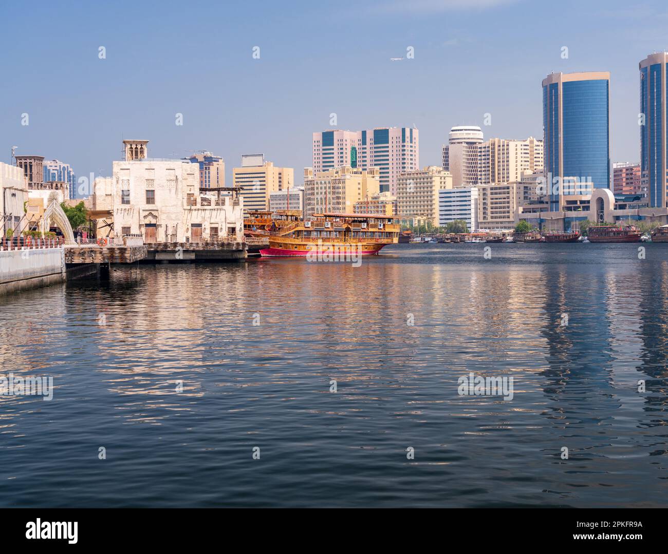 View along the Creek towards Deira with large dhow tour boats docked by ...