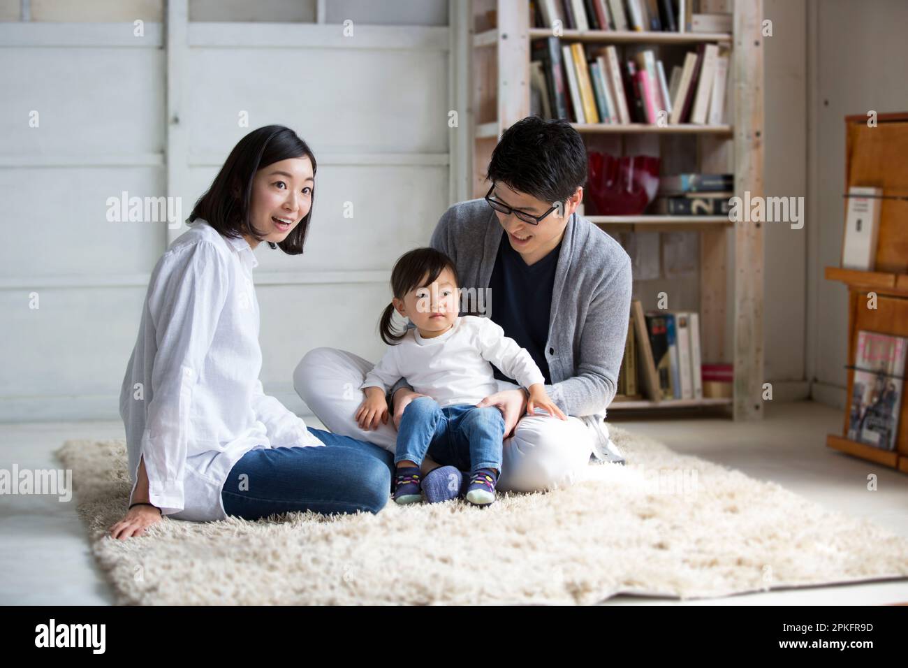 Family hanging out in the living room Stock Photo - Alamy