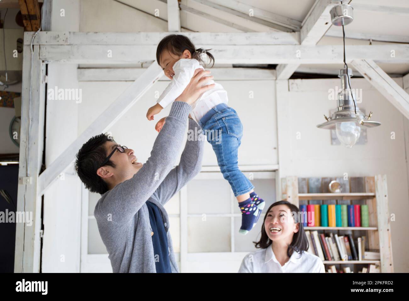 Family hanging out in the living room Stock Photo - Alamy