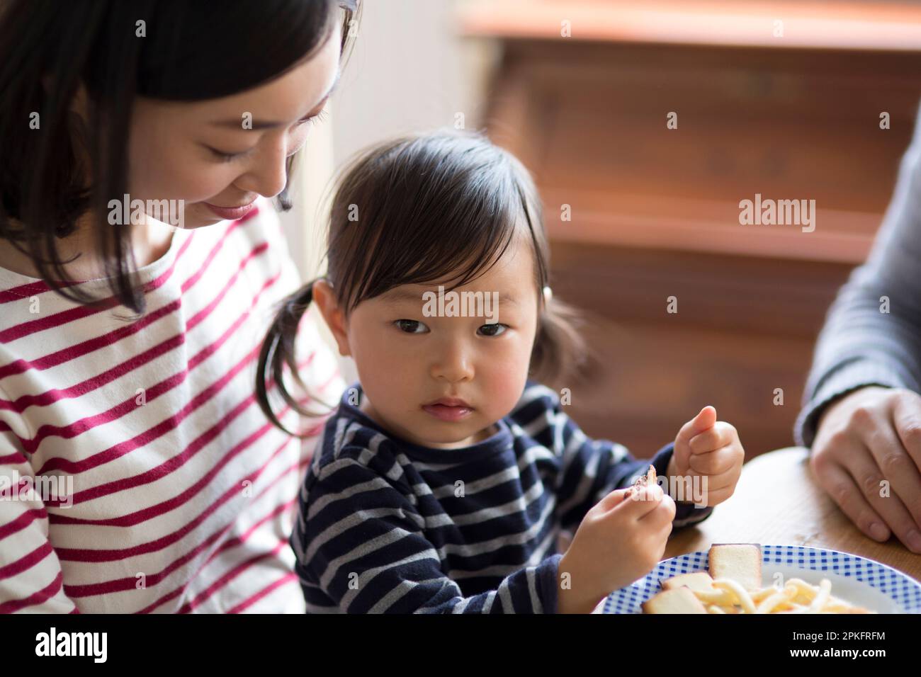 Family hanging out in the living room Stock Photo - Alamy