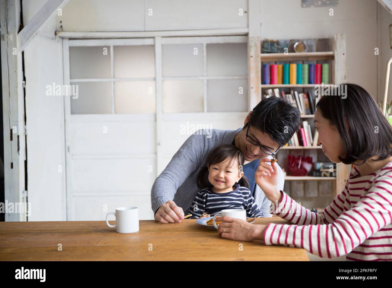 Family hanging out in the living room Stock Photo - Alamy