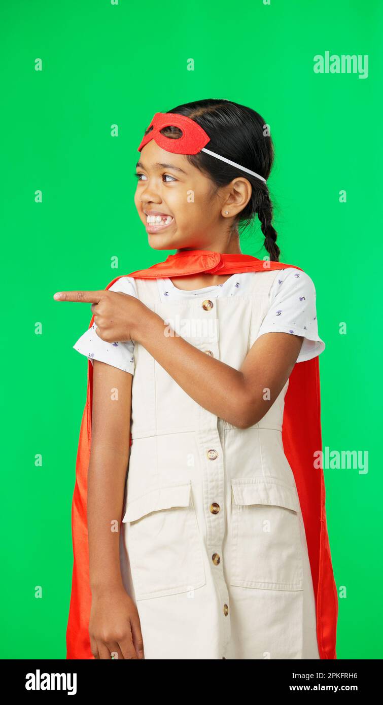 Face, superhero costume and girl pointing on green screen in studio ...
