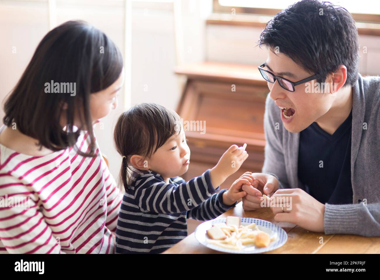Family eating a snack Stock Photo - Alamy