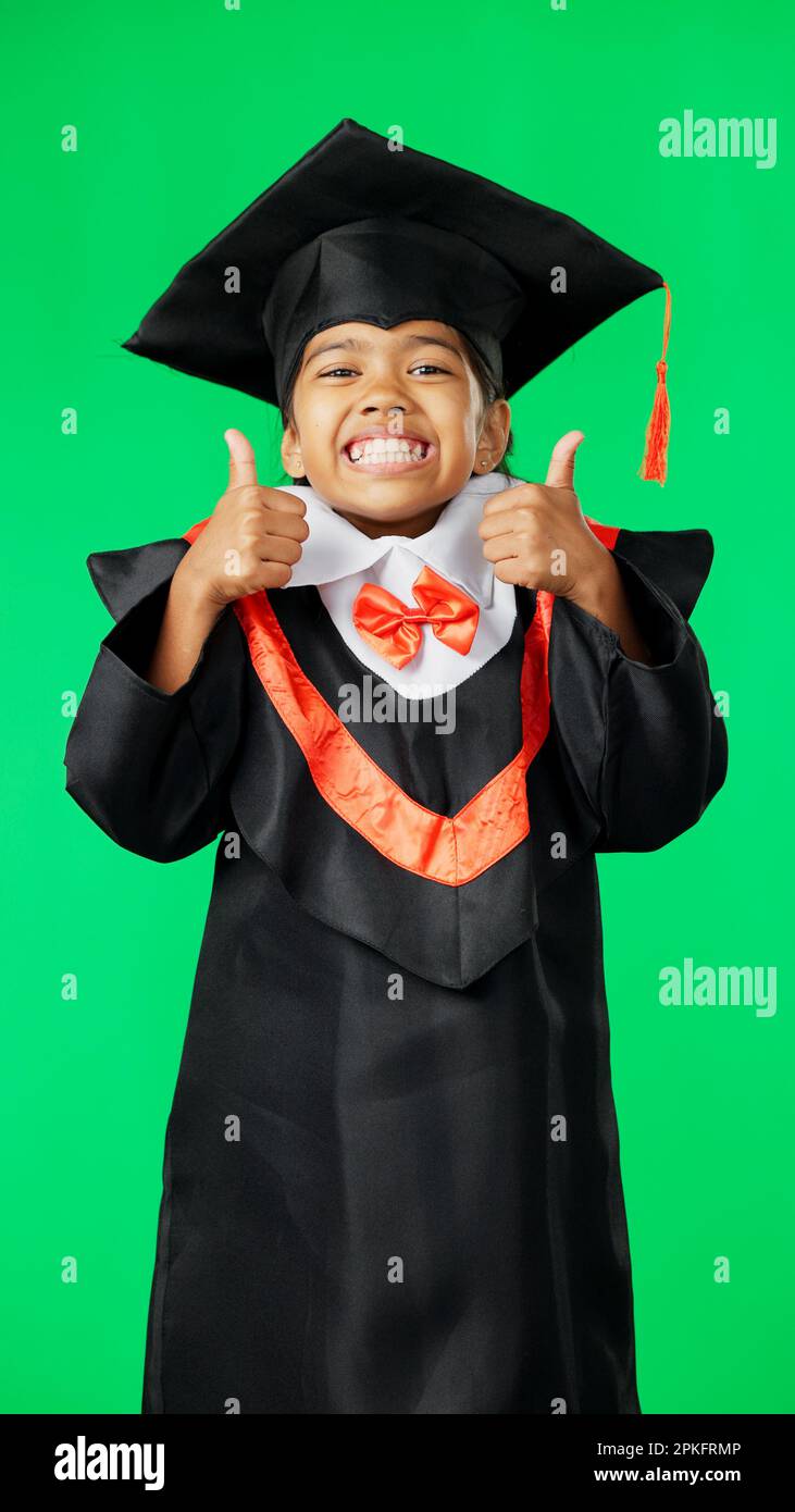 Graduation, happy and face of a child with a thumbs up on a green ...