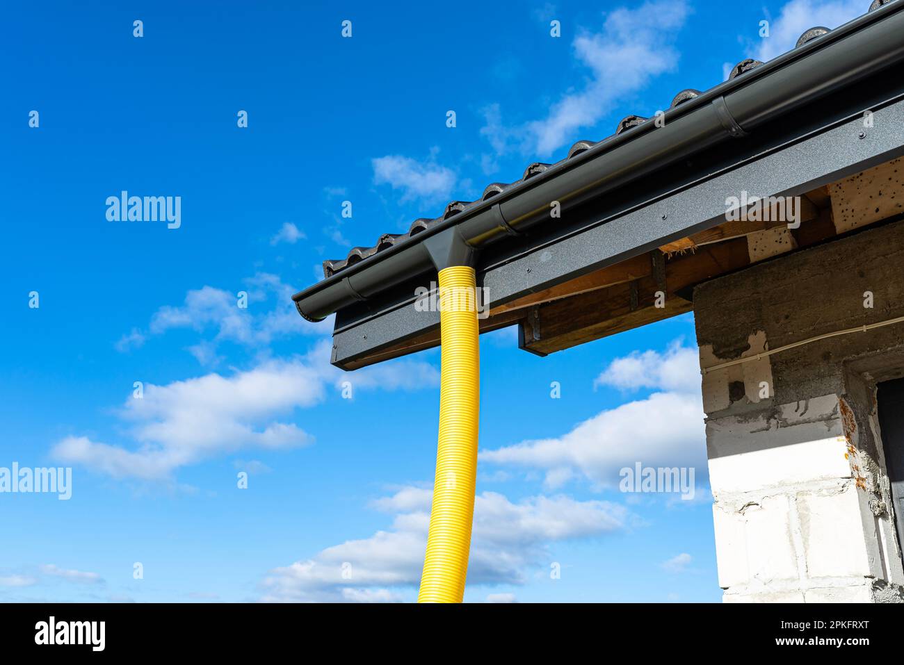 100mm diameter yellow PVC pipe connected to the end of the gutter on ...