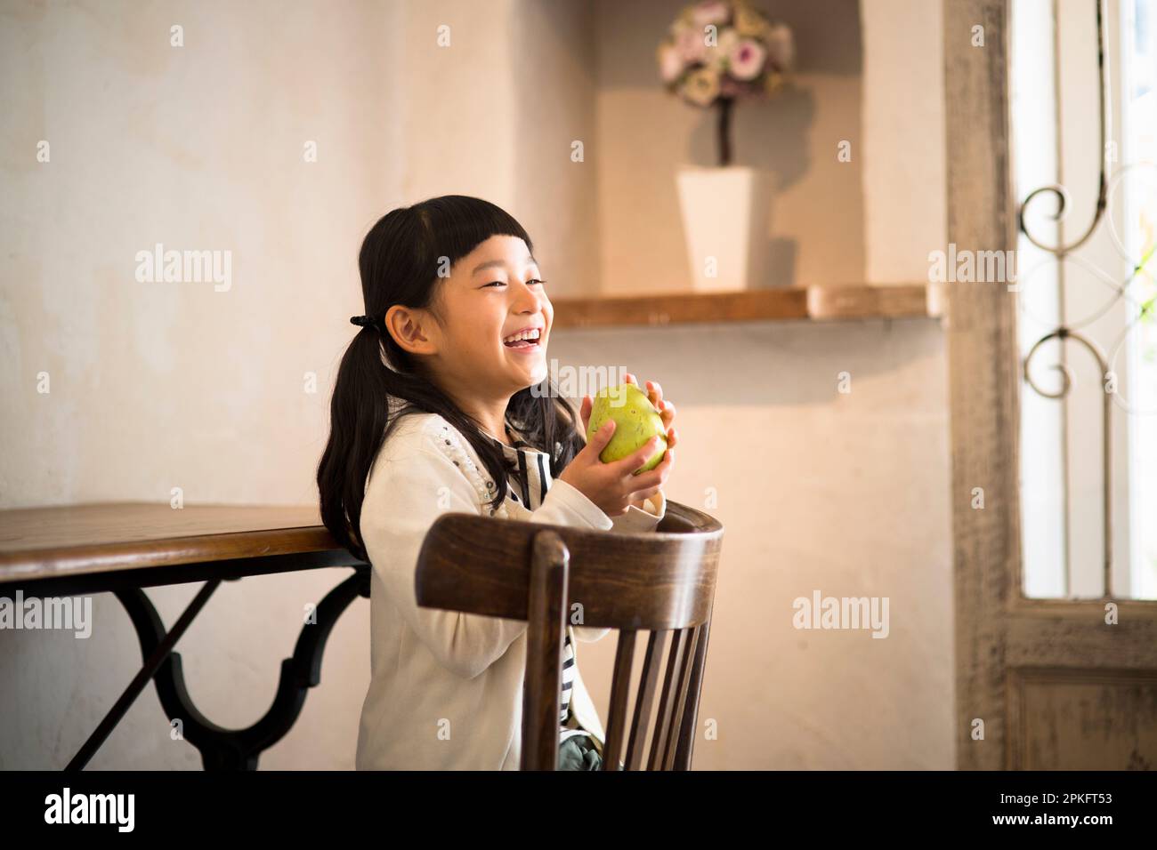 Girl with fruits in a room Stock Photo - Alamy