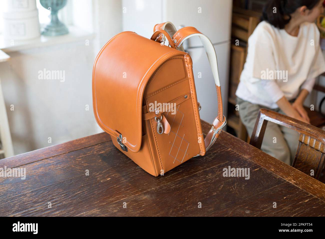 School bag on table Stock Photo - Alamy