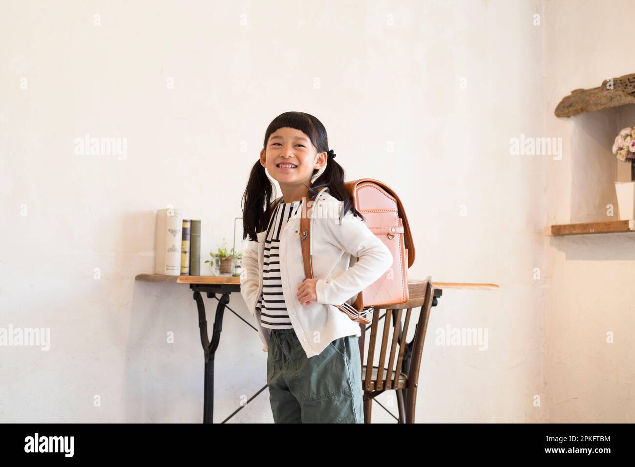 Elementary school girl carrying her school bag Stock Photo - Alamy