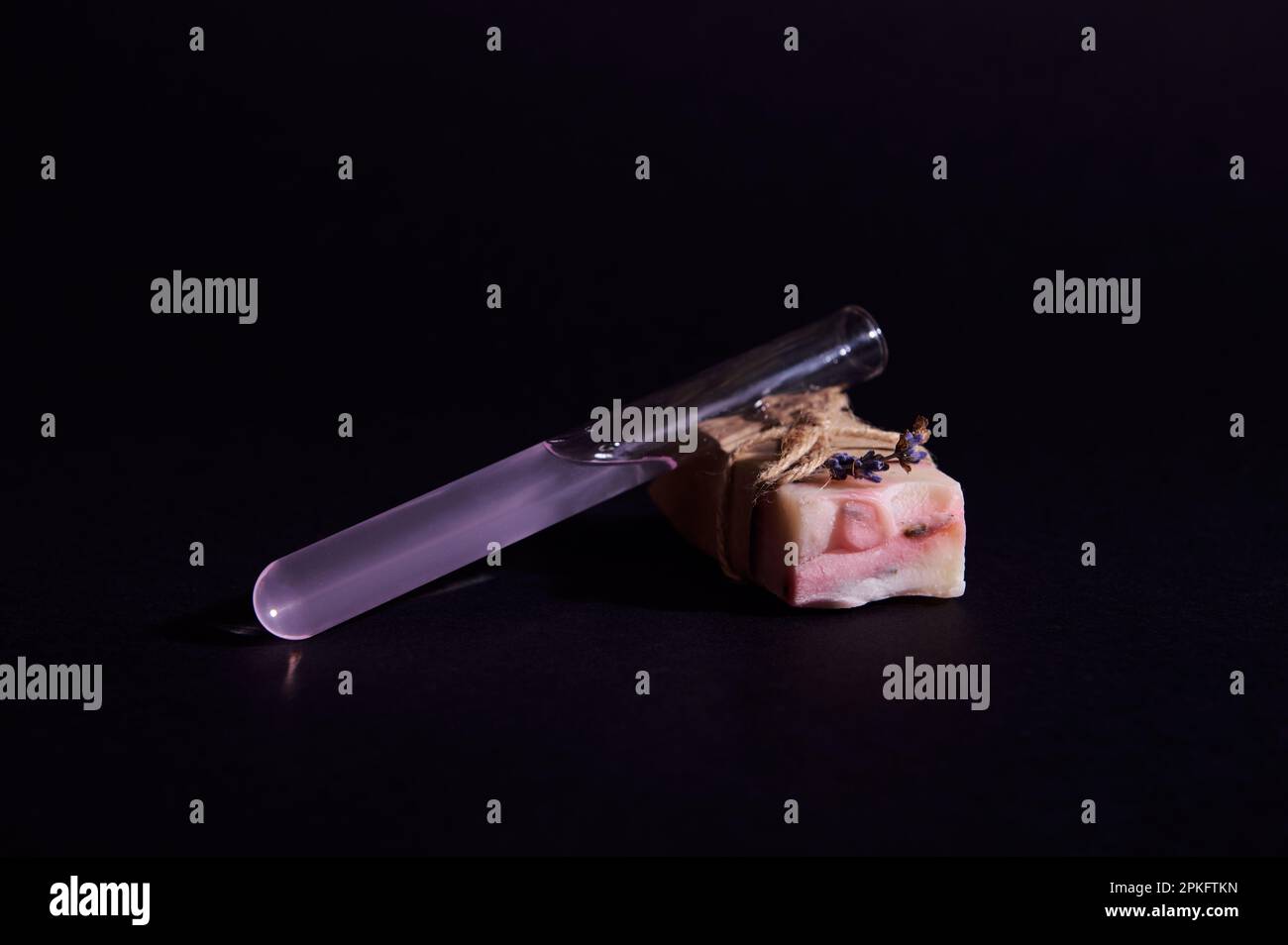 Still life Purple lavender extract in laboratory test tube and a bar of ...