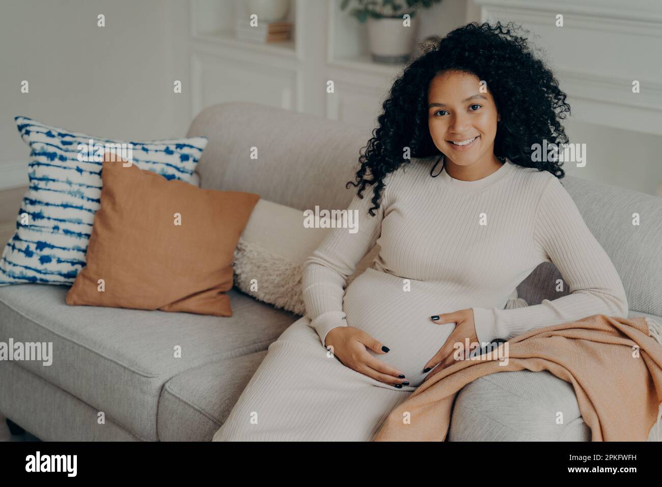 Happy pregnancy time. Cheerful young expectant lovely mixed race young ...