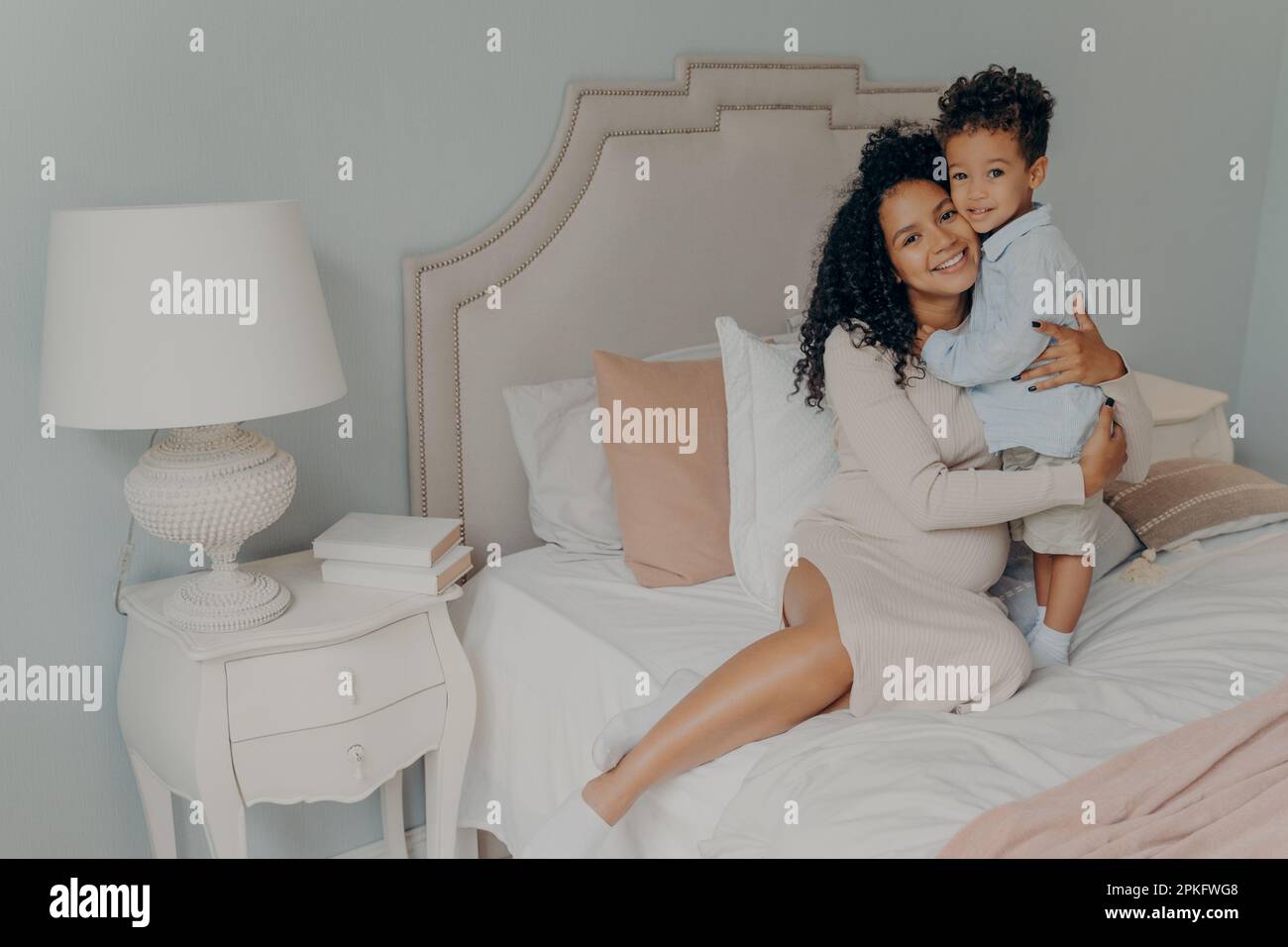 Happy pregnant mixed race lady expecting another child and enjoying ...