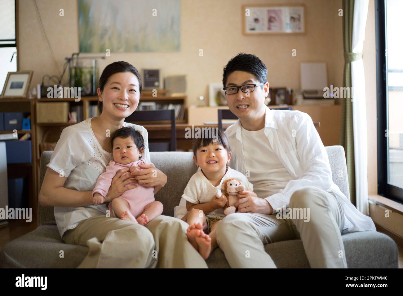 Family relaxing in the living room Stock Photo - Alamy