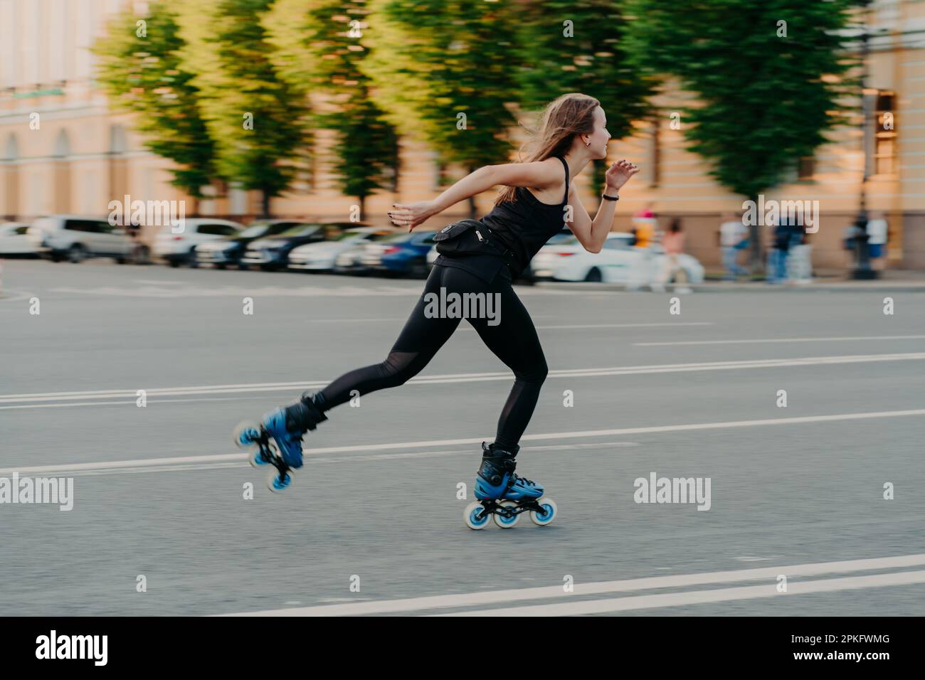 Professional female roller demonstrates her abilities of rollerblading ...