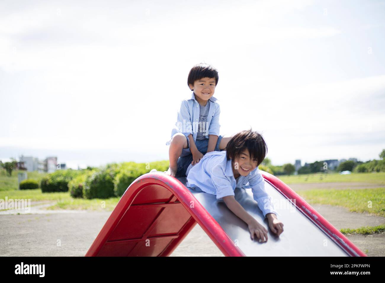 Playing on the slide hi-res stock photography and images - Alamy