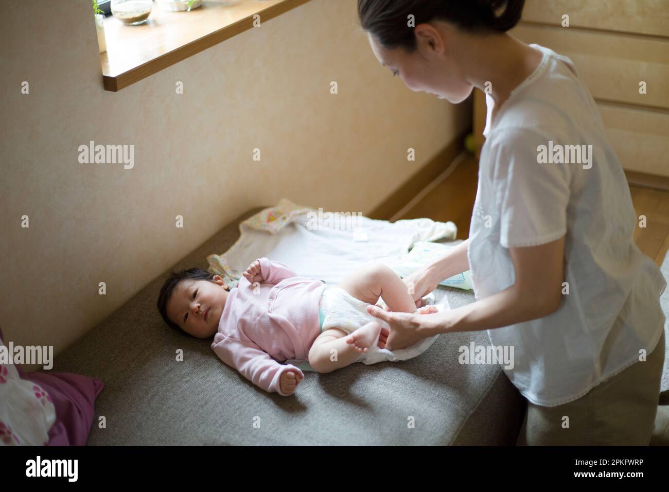 Asian mother changing diaper hi-res stock photography and images - Alamy
