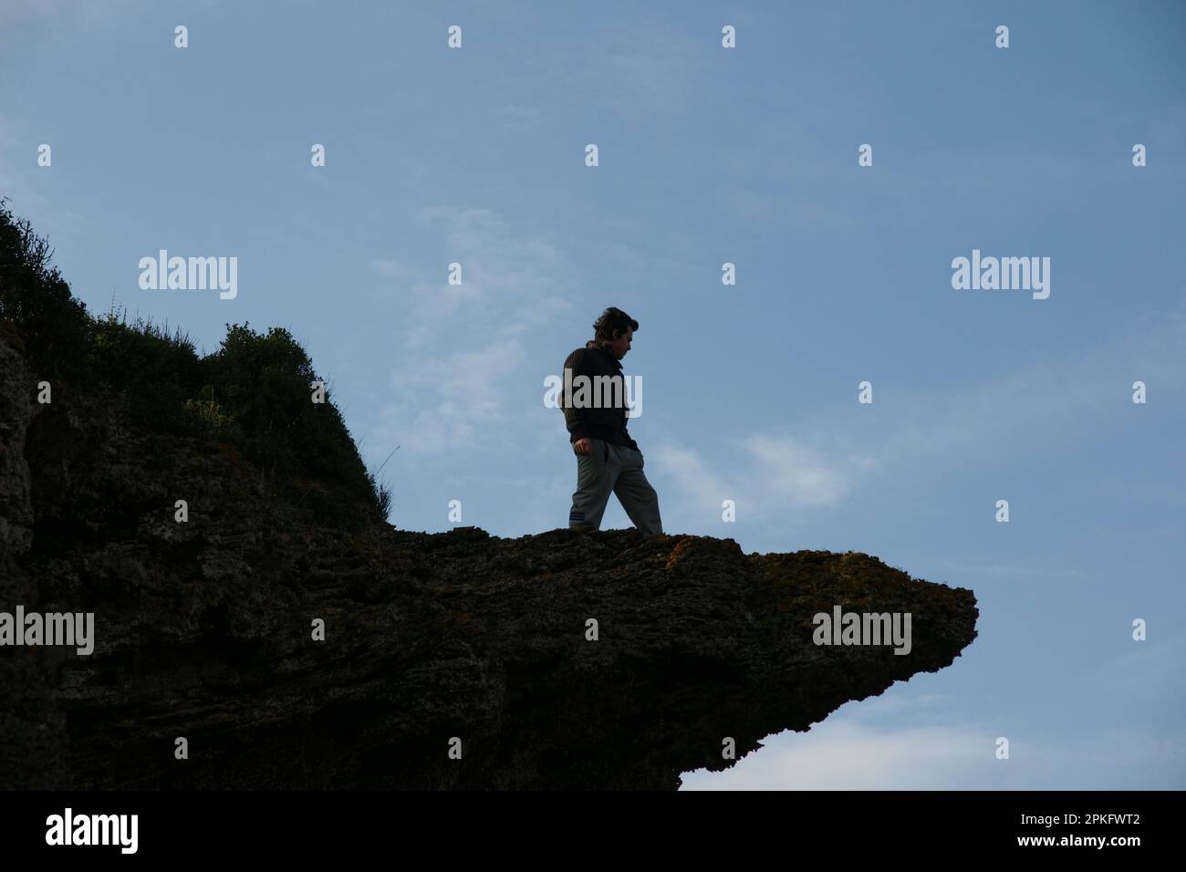 People posing on the cliff Stock Photo - Alamy