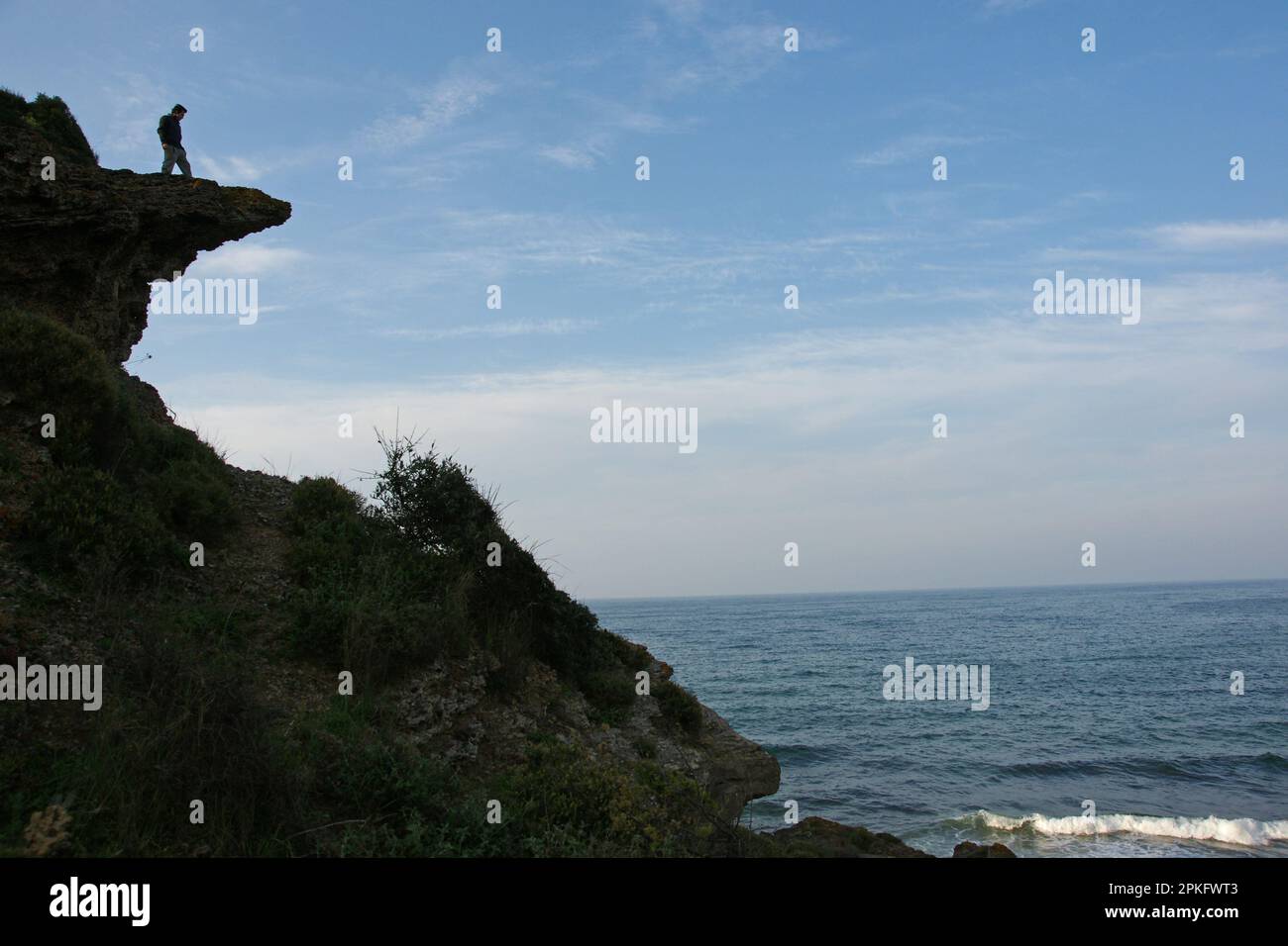 People posing on the cliff Stock Photo - Alamy