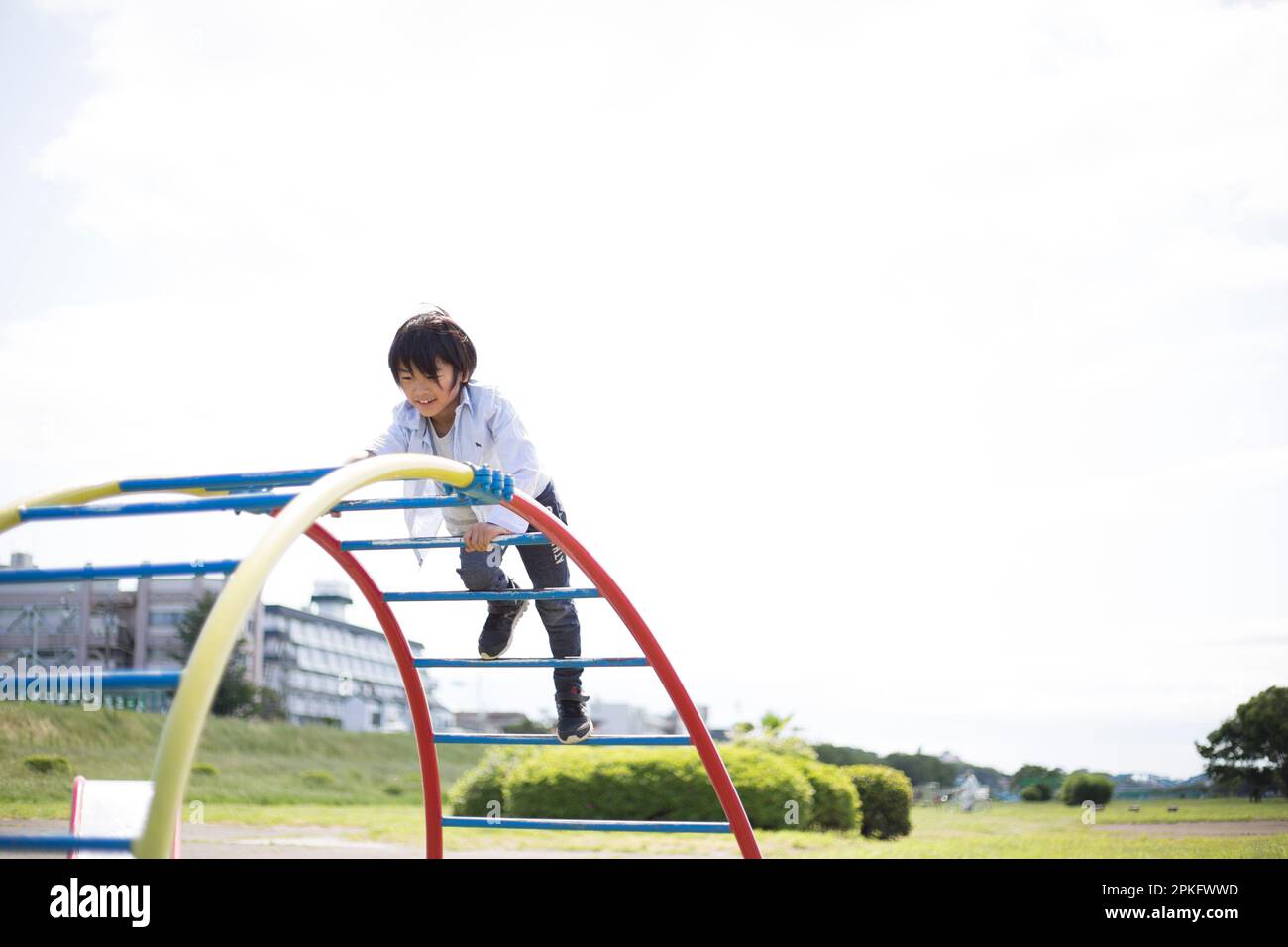 Elementary school boy playing on the playground equipment Stock Photo ...