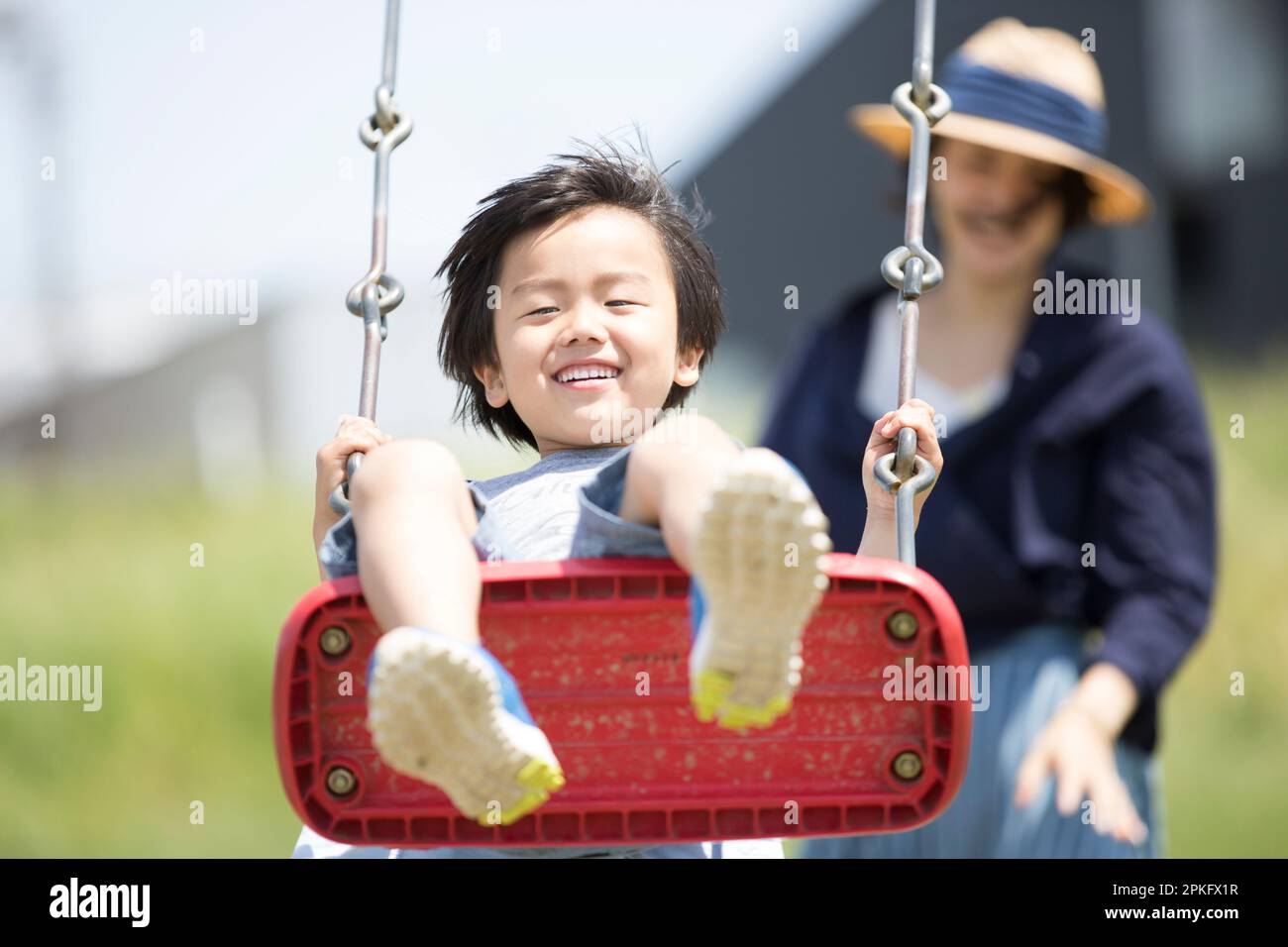 Child pushed on swing hi-res stock photography and images - Alamy