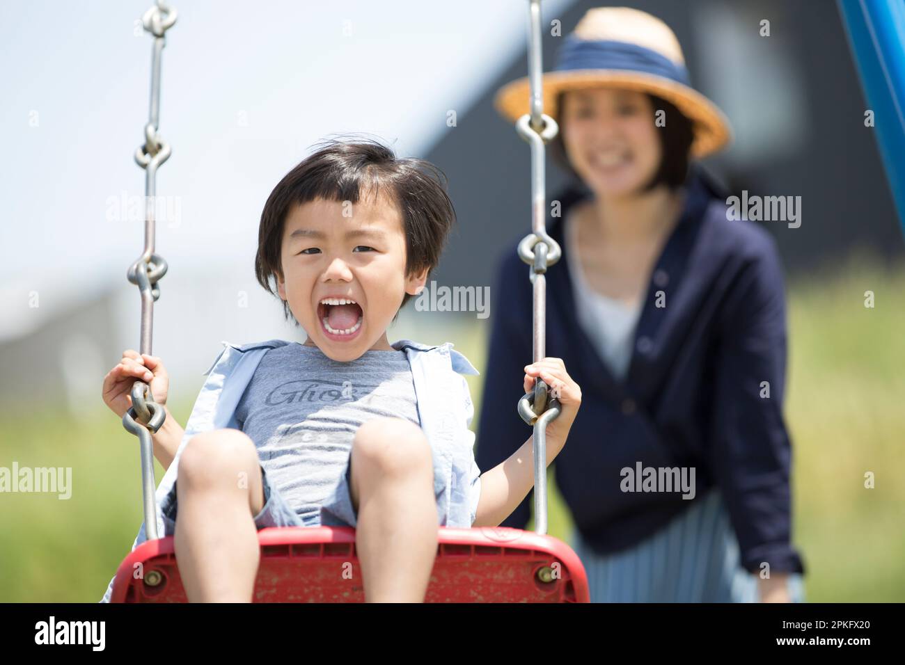 Pushed child on swing hi-res stock photography and images - Alamy