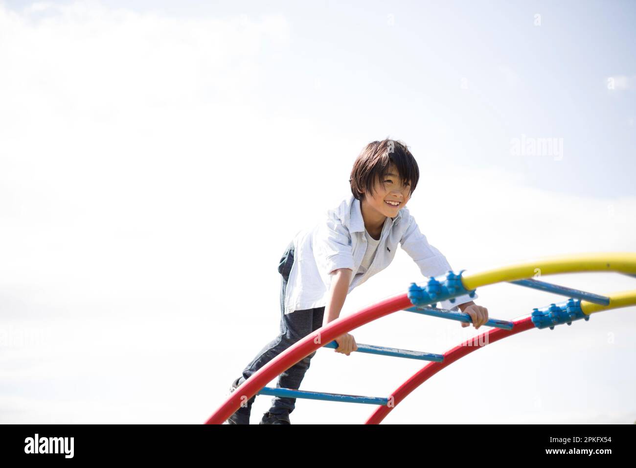Elementary school boy playing on the playground equipment Stock Photo ...