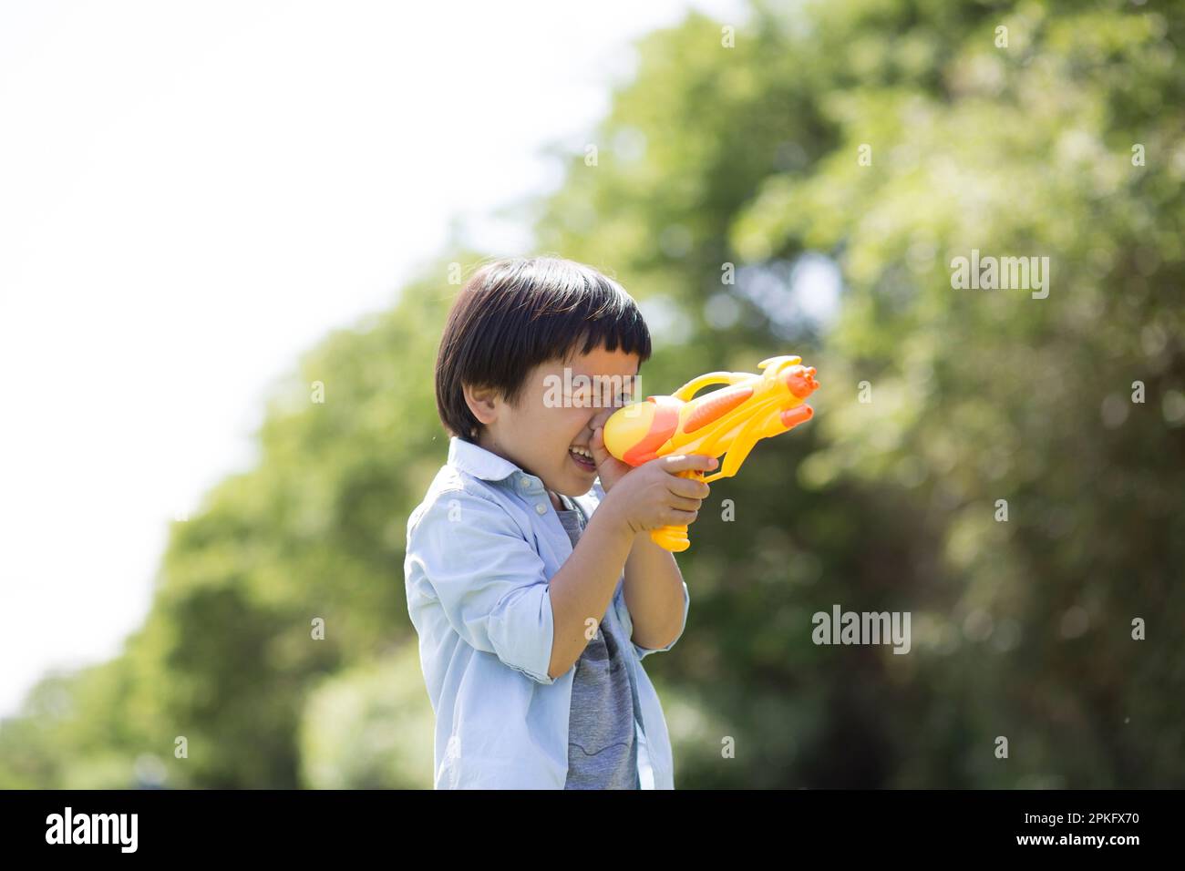 Boy with water pistol Stock Photo - Alamy
