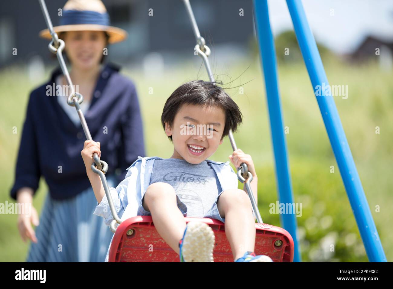 Child pushed on swing hi-res stock photography and images - Alamy