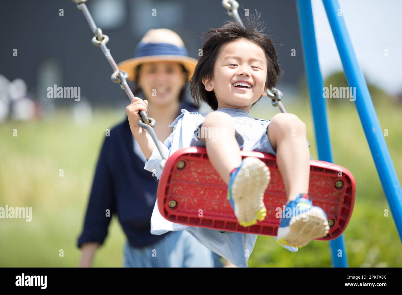Pushed child on swing hi-res stock photography and images - Alamy