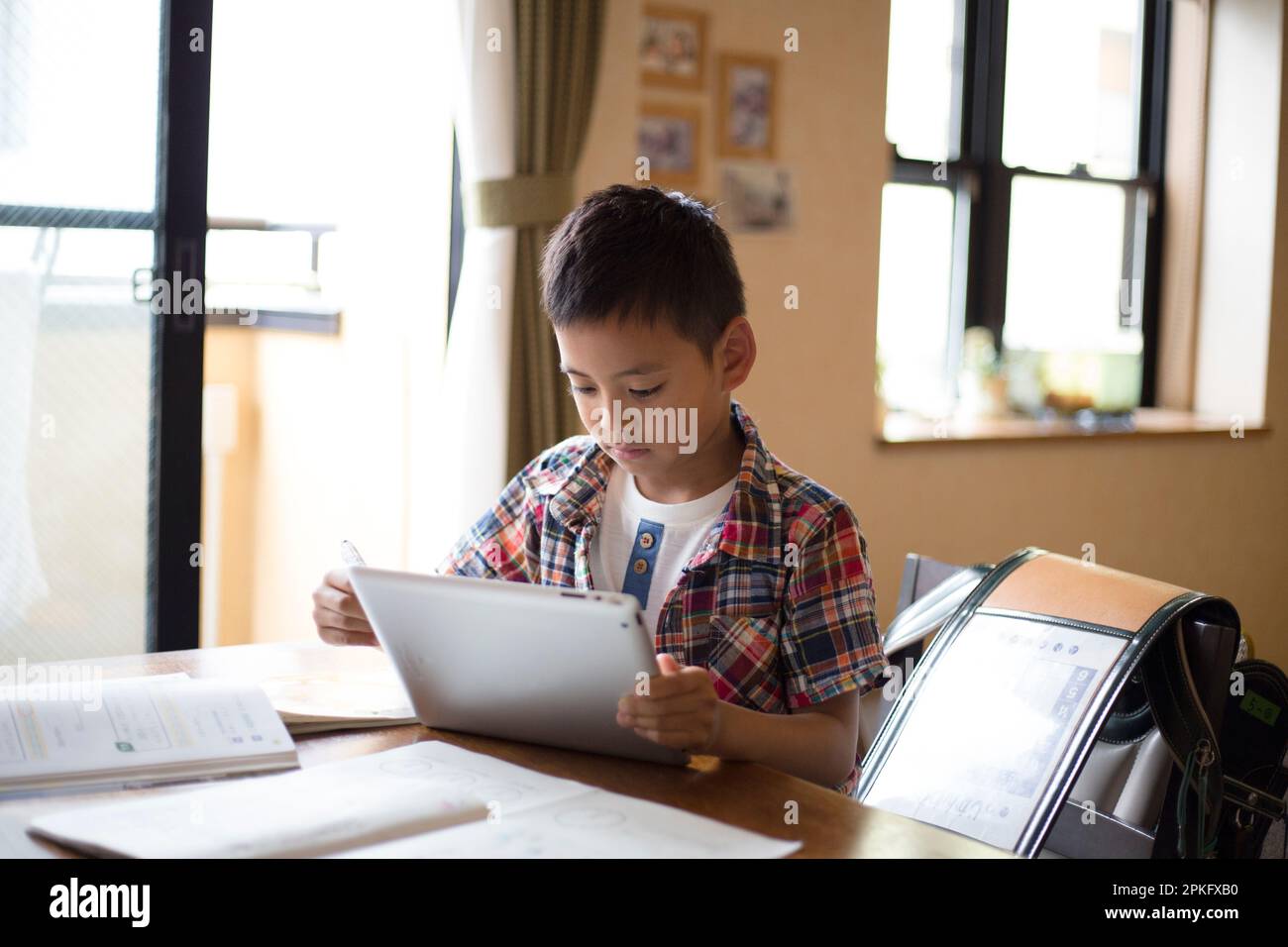 An elementary school boy studying with a tablet Stock Photo - Alamy