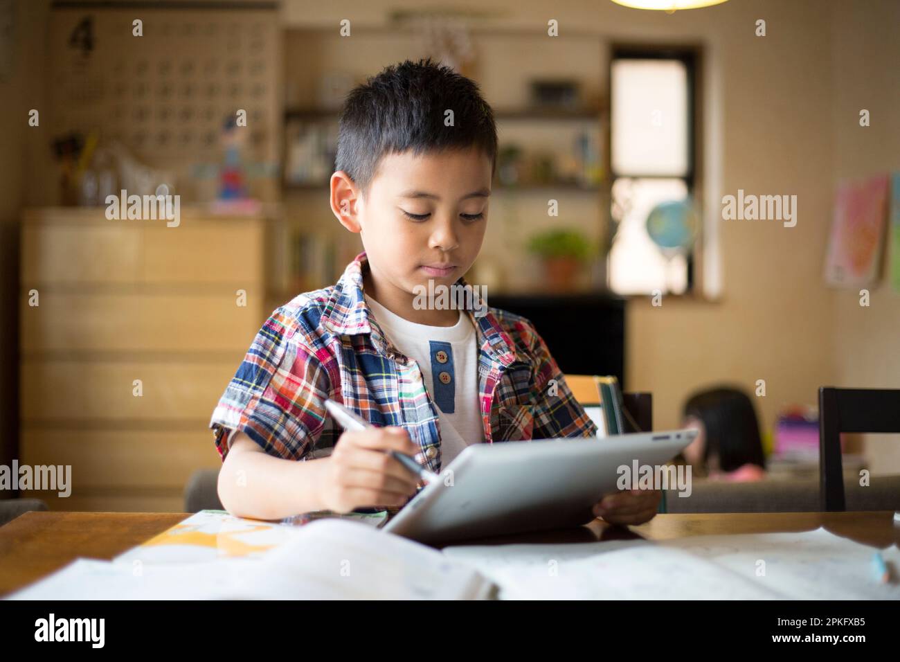 An elementary school boy studying with a tablet Stock Photo - Alamy