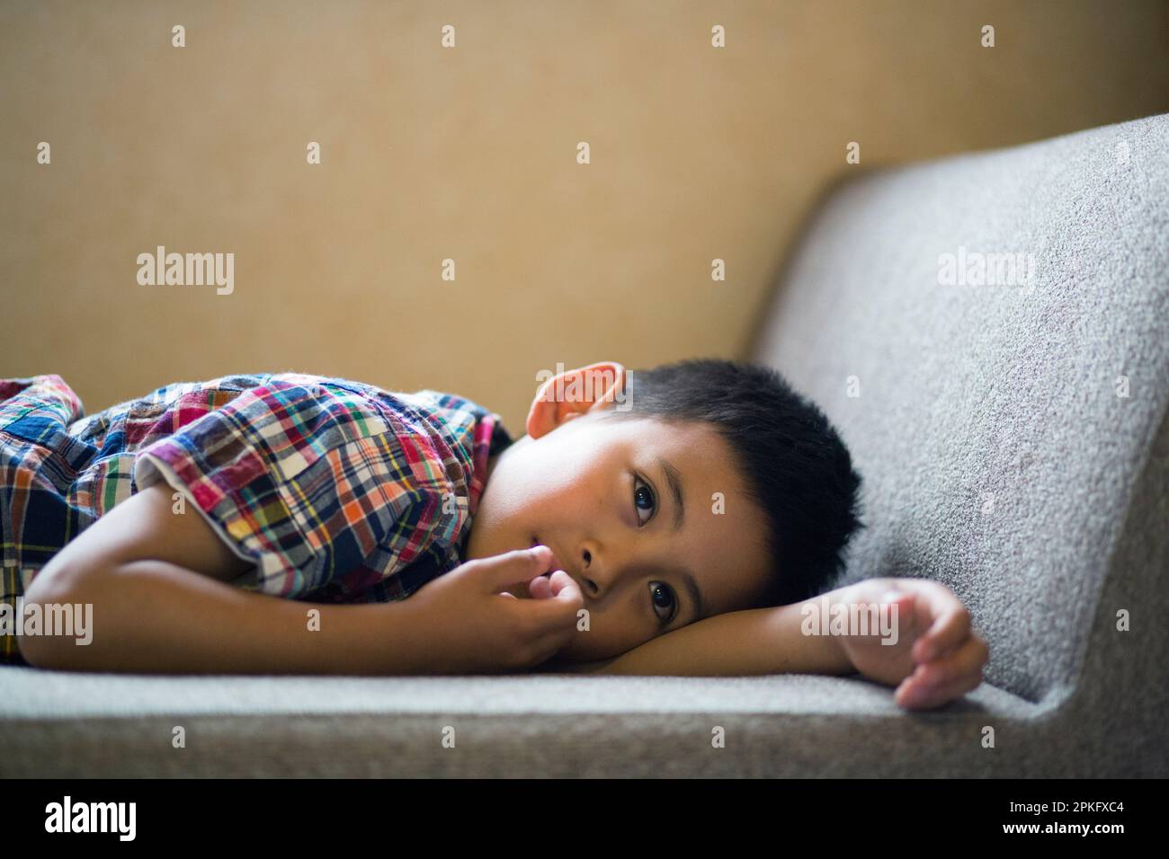 Boy lying couch hi-res stock photography and images - Alamy