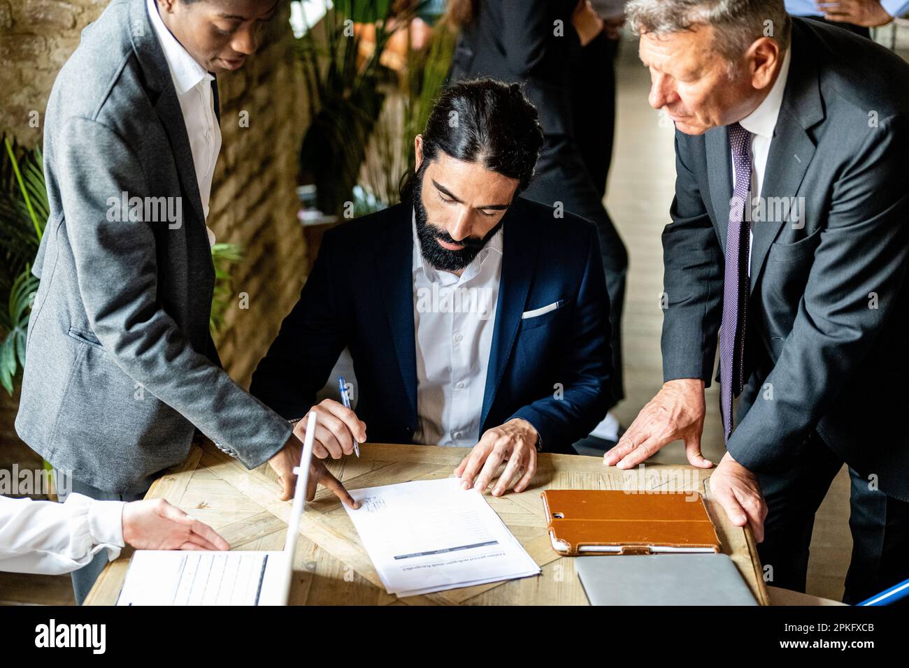 Successful corporate meeting business people, male manager signing ...