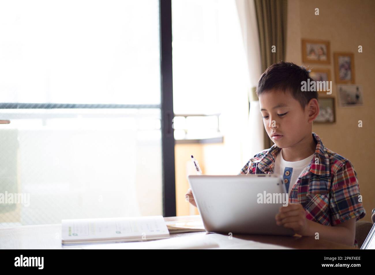 An elementary school boy studying with a tablet Stock Photo - Alamy