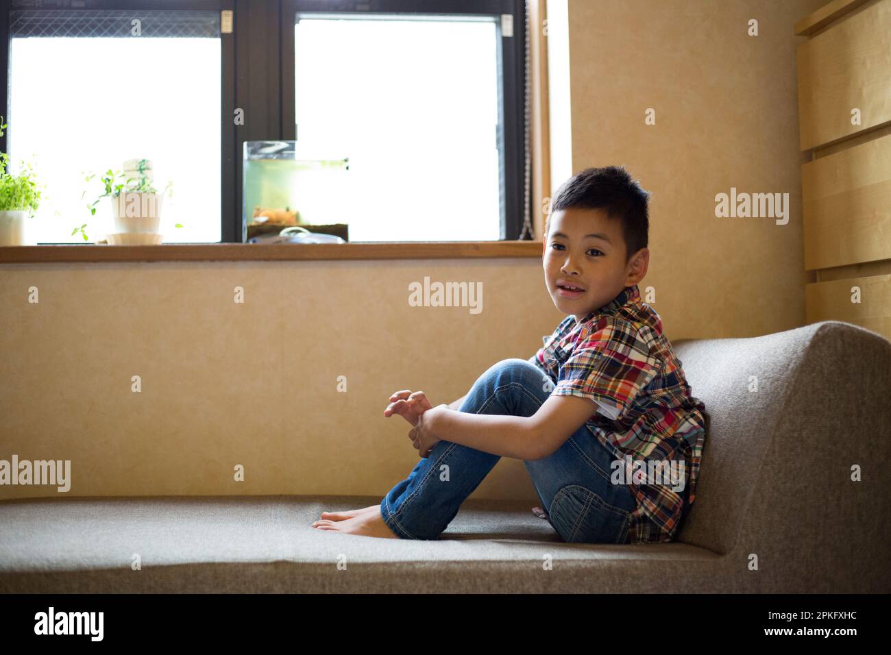 Boy sitting on the sofa hi-res stock photography and images - Alamy