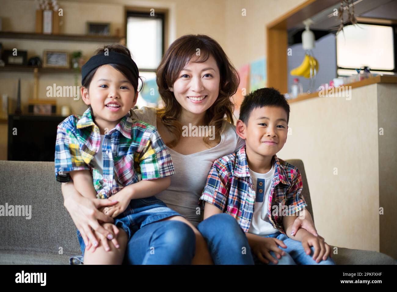 Parent and child relaxing on living room sofa Stock Photo - Alamy