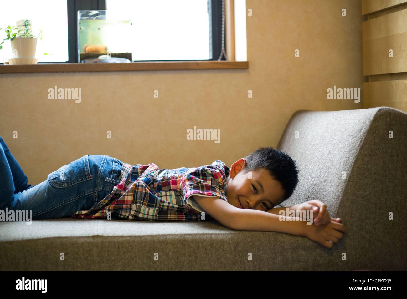 Boy lying couch hi-res stock photography and images - Alamy