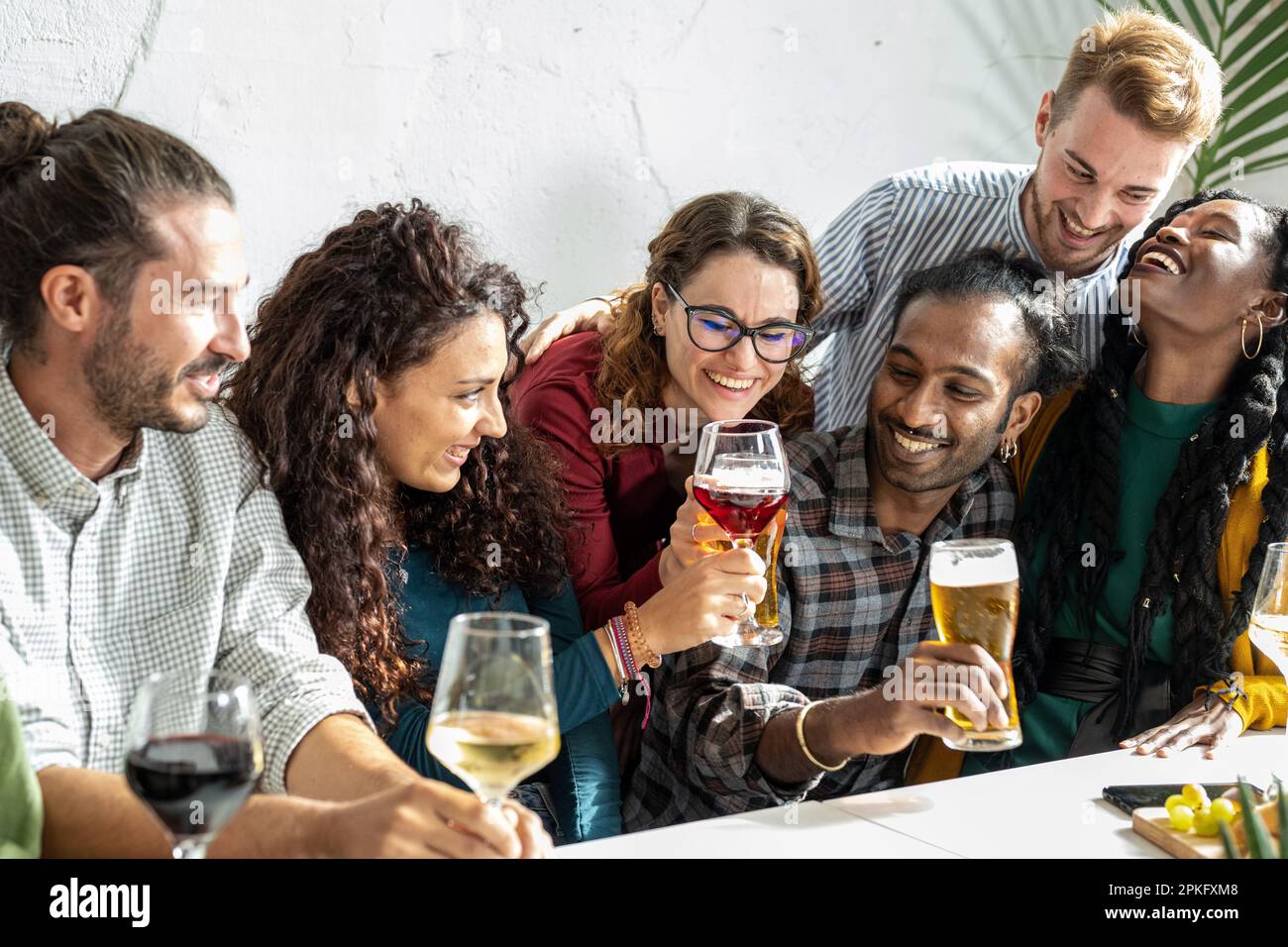 Happy friends cheering and drinking beverage at celebration party ...