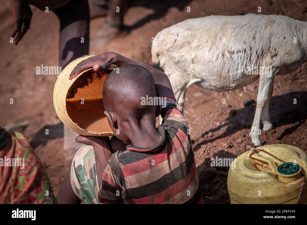 Turkana, Kenya. 18th Feb, 2023. Child drinking brown water from a well ...