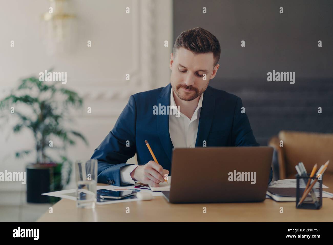 Serious concentrated skilled male entrepreneur checks financial ... Serious concentrated skilled male entrepreneur checks financial ...