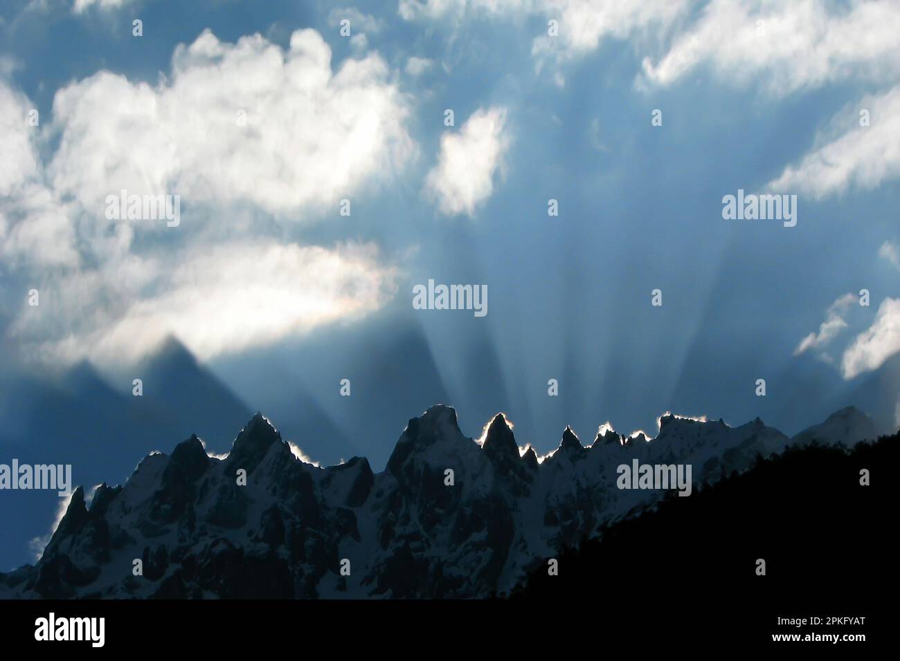 Spectacular sun rise with white clouds in the sky, sun rays cutting off ...