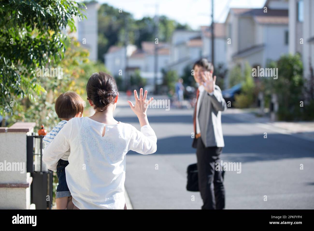 Two People Waving Goodbye