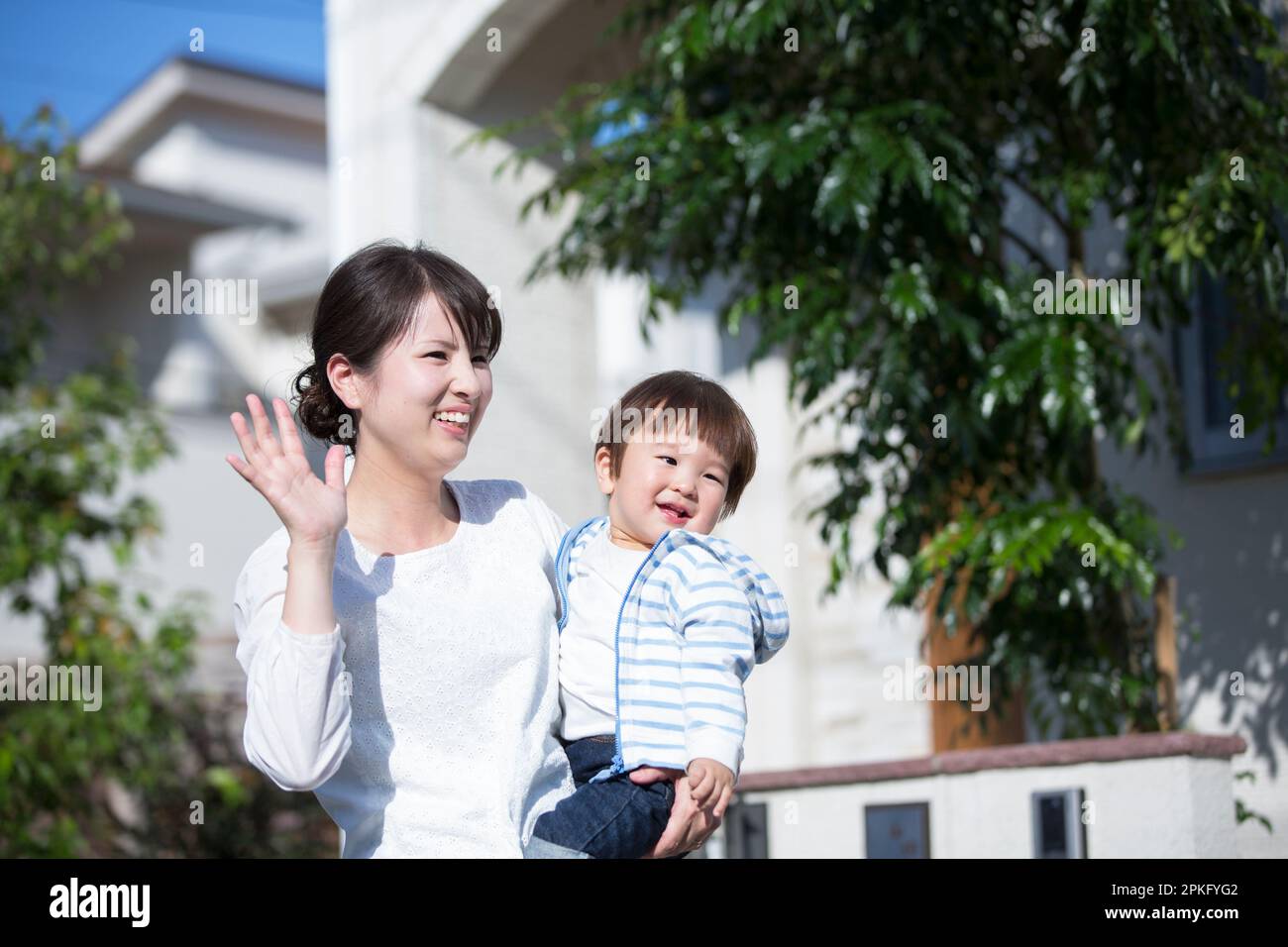 Wife with child waving her hand away Stock Photo - Alamy