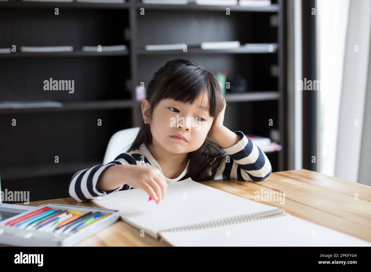 Girl thinking about what to draw Stock Photo - Alamy