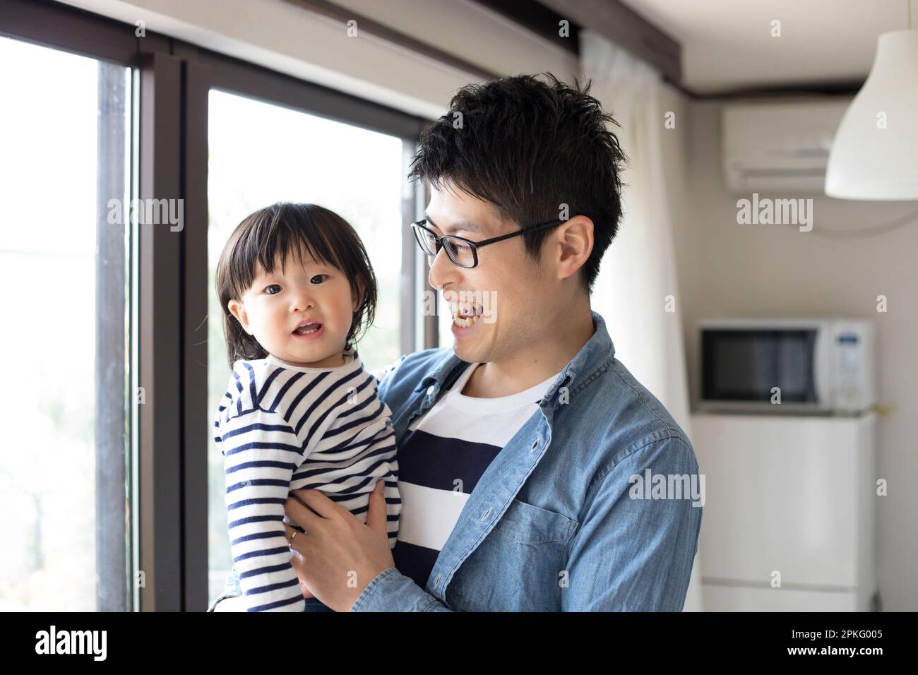A child being held by his father Stock Photo - Alamy