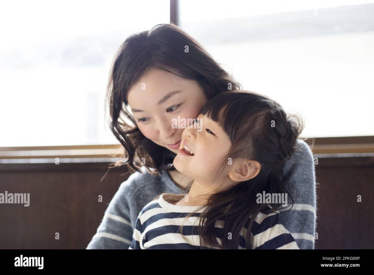 A mother and a girl putting their cheeks together Stock Photo - Alamy