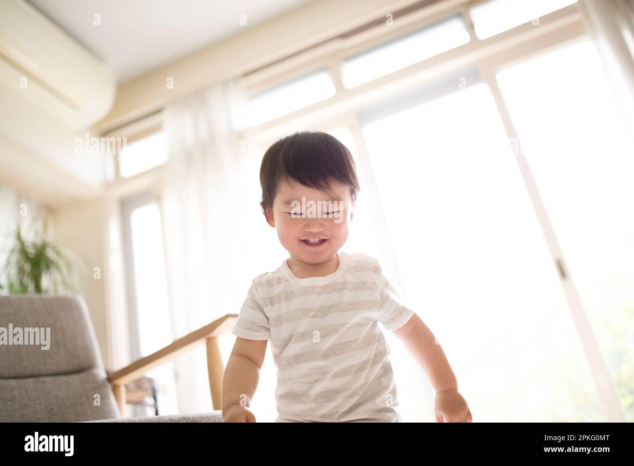 Toddler playing alone in the living room Stock Photo - Alamy