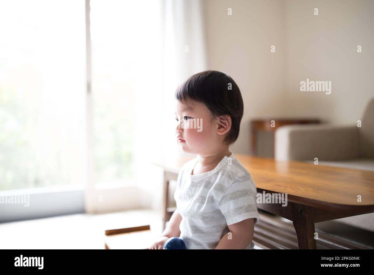 Toddler playing alone in the living room Stock Photo - Alamy