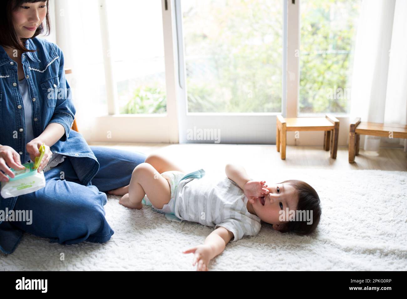 Mother changing her child Stock Photo - Alamy