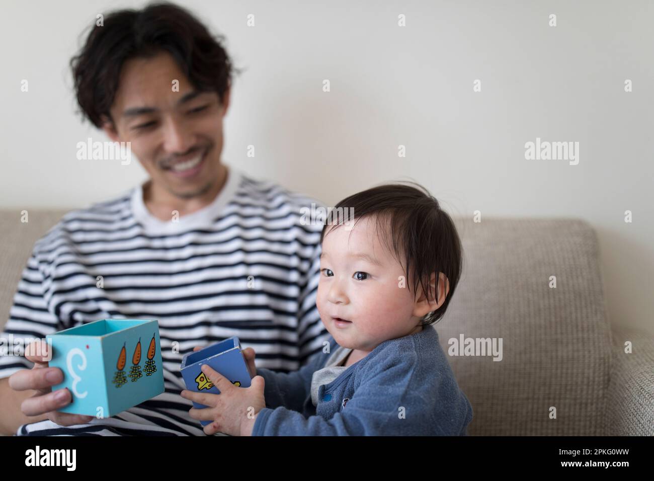 Baby playing with father Stock Photo - Alamy